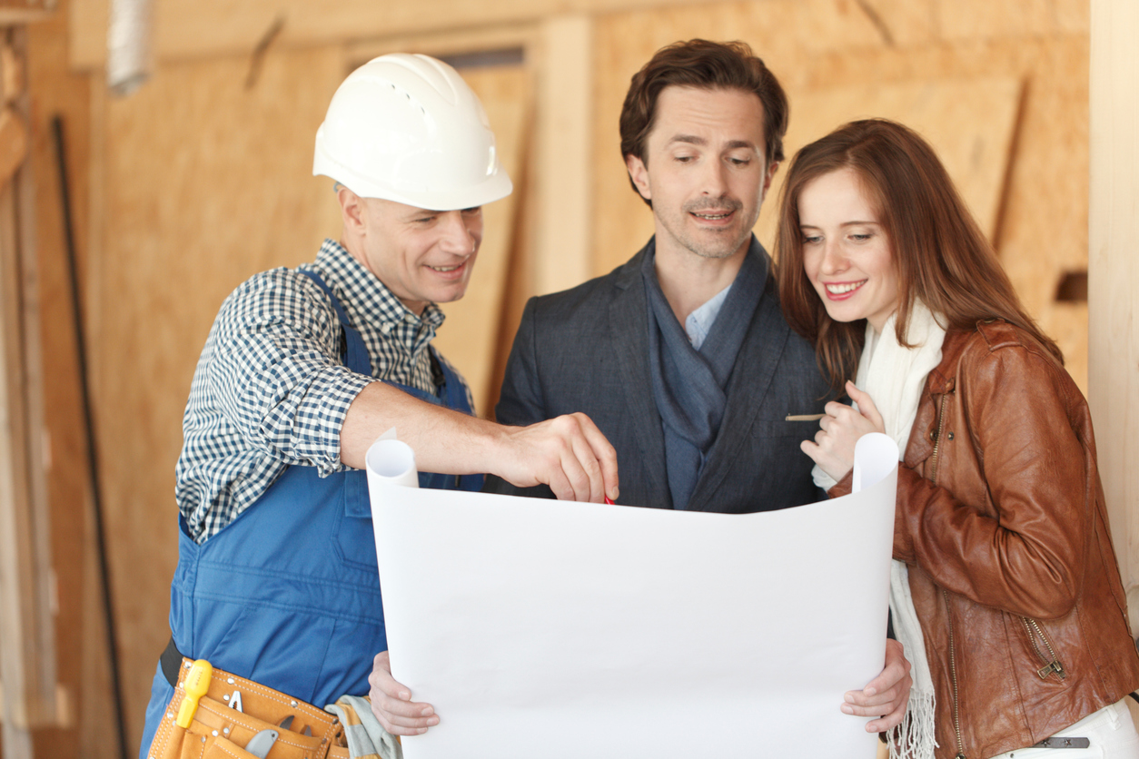 Worker shows house design plans : eCommission